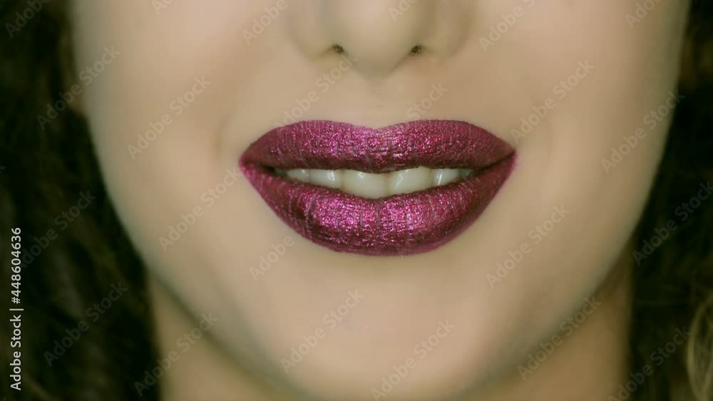 4k Closeup of a beautiful woman lips with beautiful lilac make up ...
