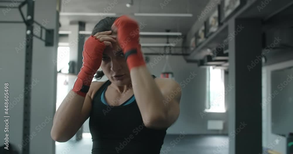 Mixed martial art fighter woman does shadow boxing to the camera in the ...