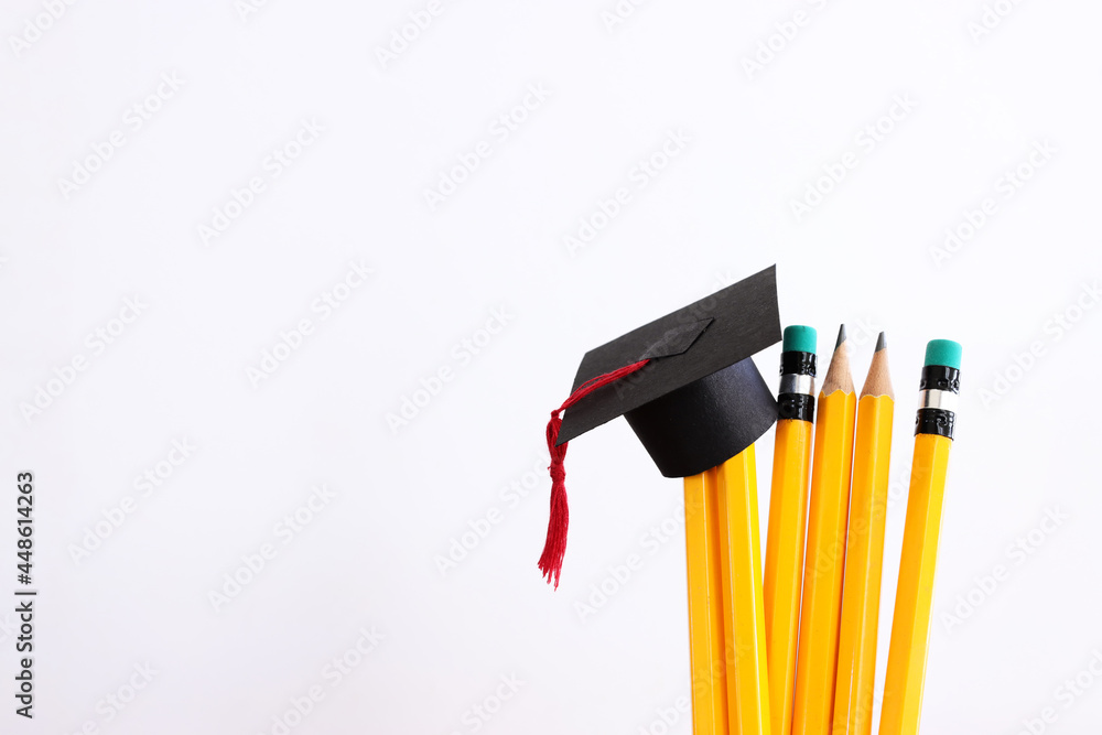 Image of education concept. Traditional graduation hat over pencils ...