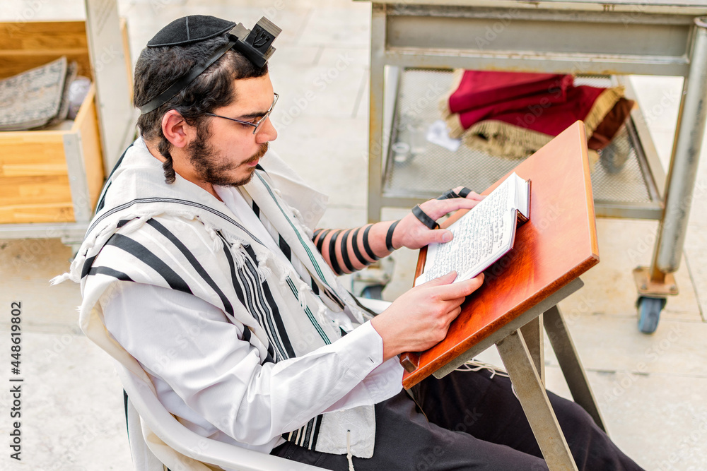 Orthodox Jewish man, wearing phylacteries (tefilin) and shawl (tallit ...