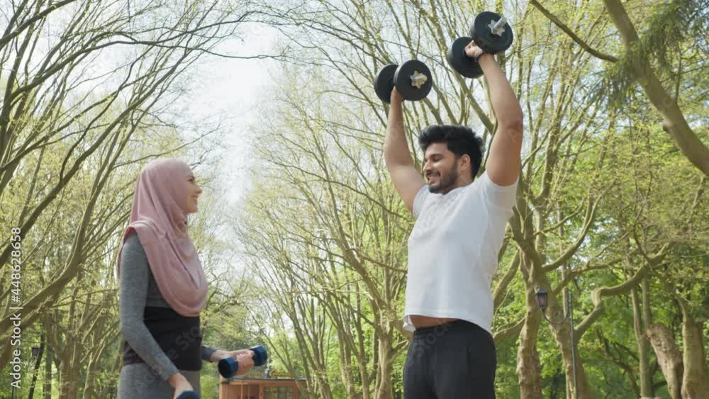 Healthy muslim couple in sportswear having outdoors workout during ...