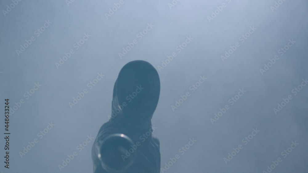 Professional fencer in protective uniform practicing maneuvers with ...