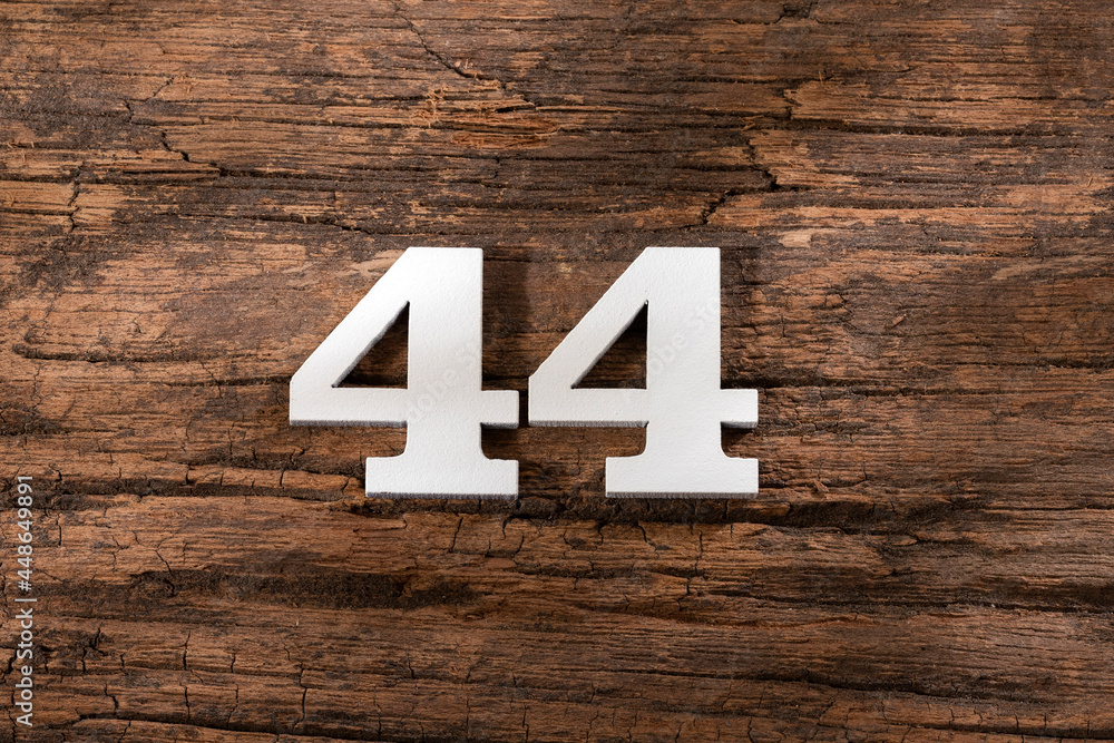 Foto Stock forty four 44 - White wooden number on rustic background ...