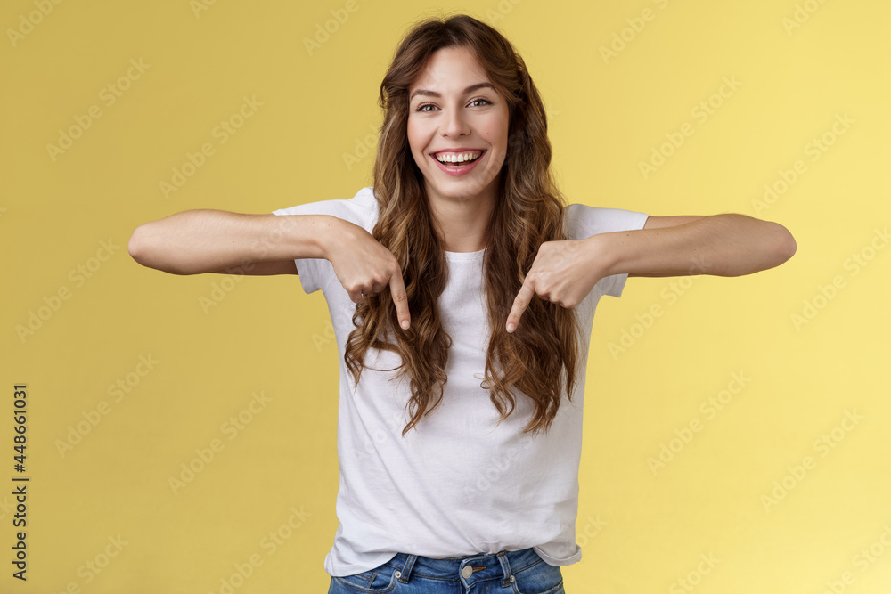Cheerful lively happy funny girl long beautiful hair pointing down ...