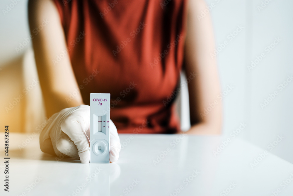 Patient woman showing result a covid-19 self test rapid antigen testing ...
