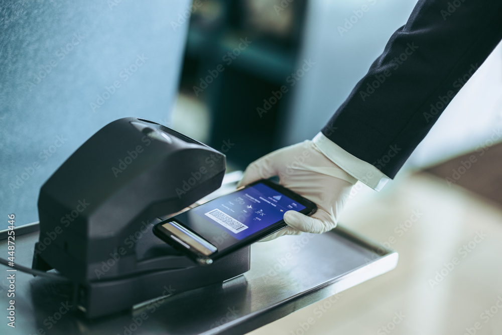 Hand of airport staff scanning boarding pass Stock Photo | Adobe Stock