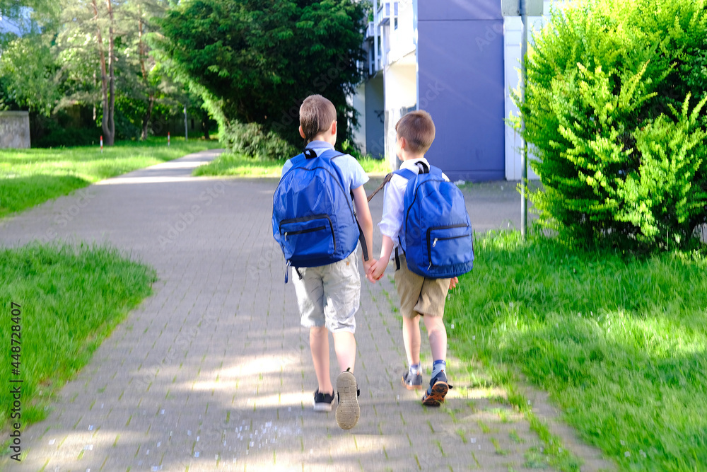 two boys, ,primary school students, children with blue school bags ...