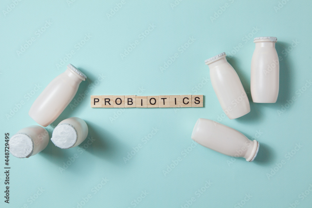 Bottles with probiotics and prebiotics dairy drink on light blue ...