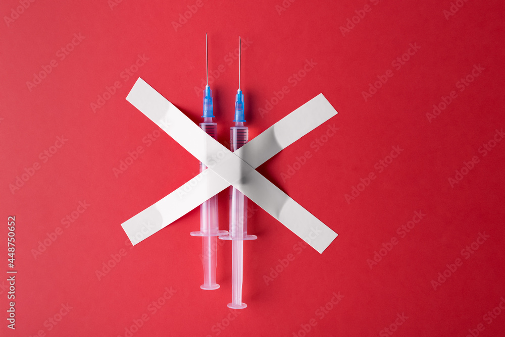 Poster Two syringes crossed with white tapes over red background with ...