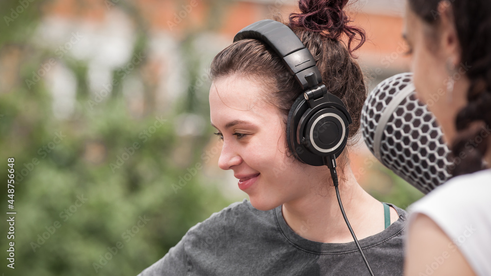 Behind the scene. Sound boom operator resting on the set and hold ...