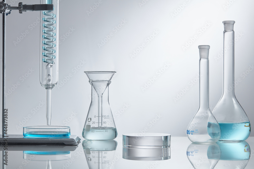 Assorted laboratory glassware equipment showcase with blue water on ...