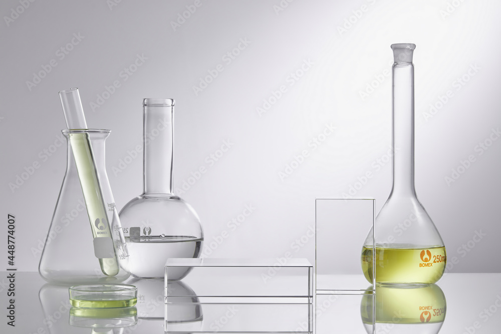 Assorted laboratory glassware equipment showcase with oil on white ...