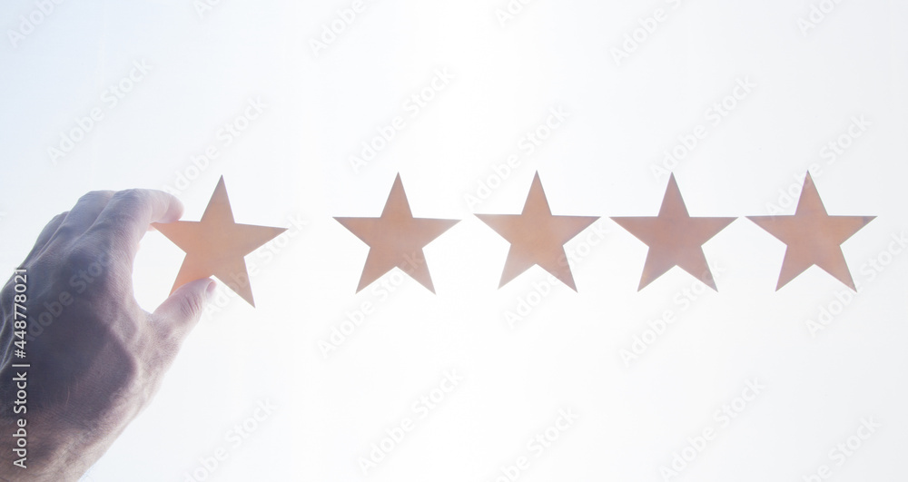 Male hand showing five star rating. Stock Photo | Adobe Stock