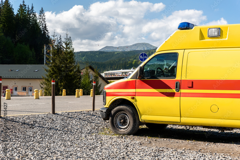 Side view of yellow ambulance rescue ems van car parked near ...