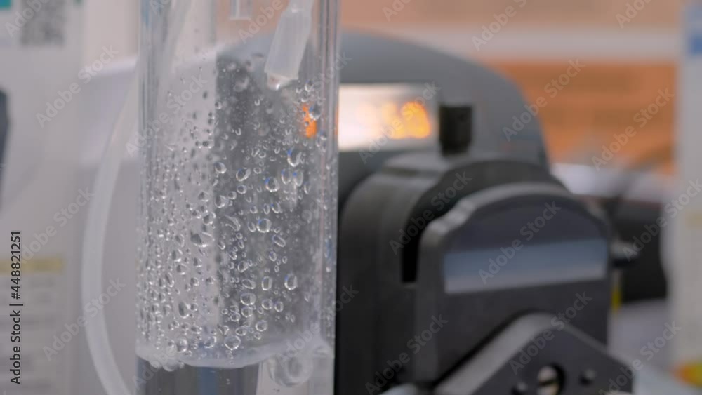 Droplets falling from tube - compact liquid dosing system: close up ...