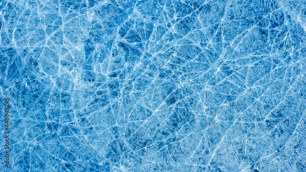 Beautiful ice texture with cracks of a frozen puddle on the asphalt for ...