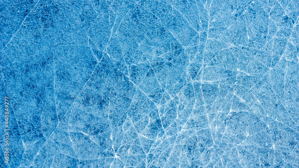 Beautiful ice texture with cracks of a frozen puddle on the asphalt for ...