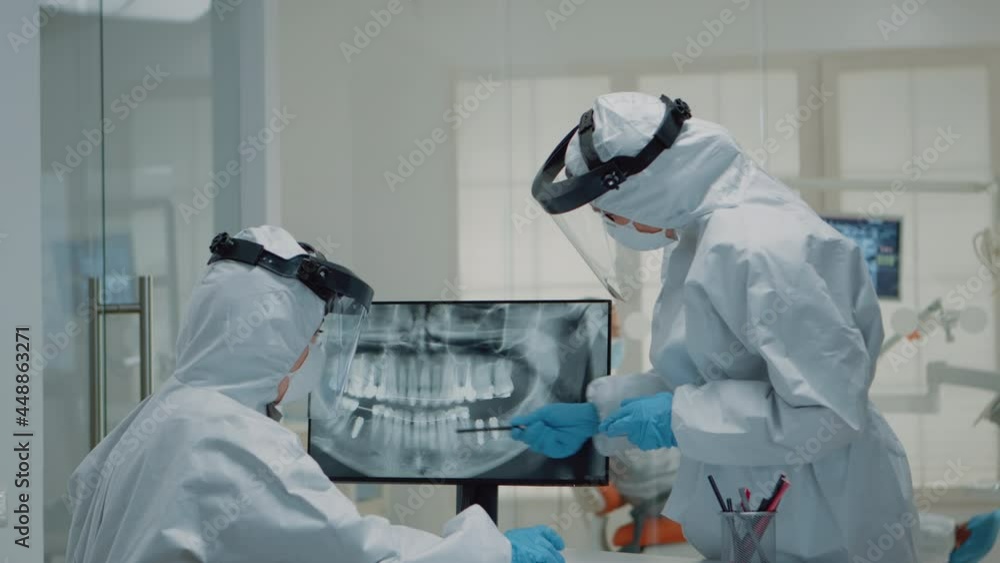 Professional stomatologist looking at teeth animation on screen and ...