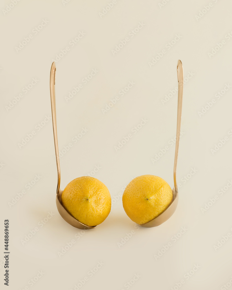 Provocative arrangement with couple of lemons in gold luxurious ladles ...