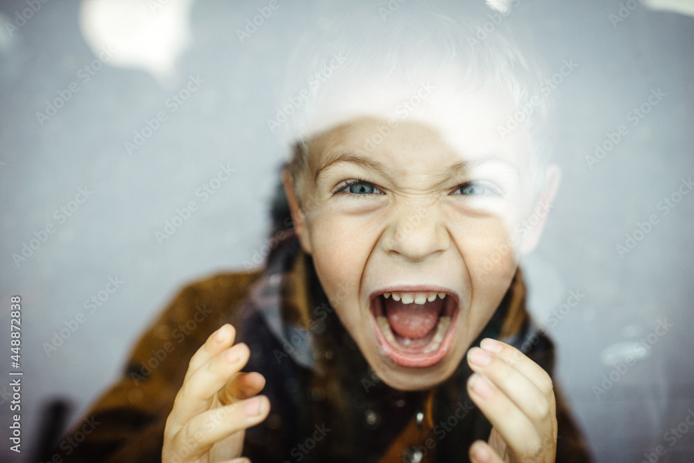 Kid screaming through window Stock Photo | Adobe Stock