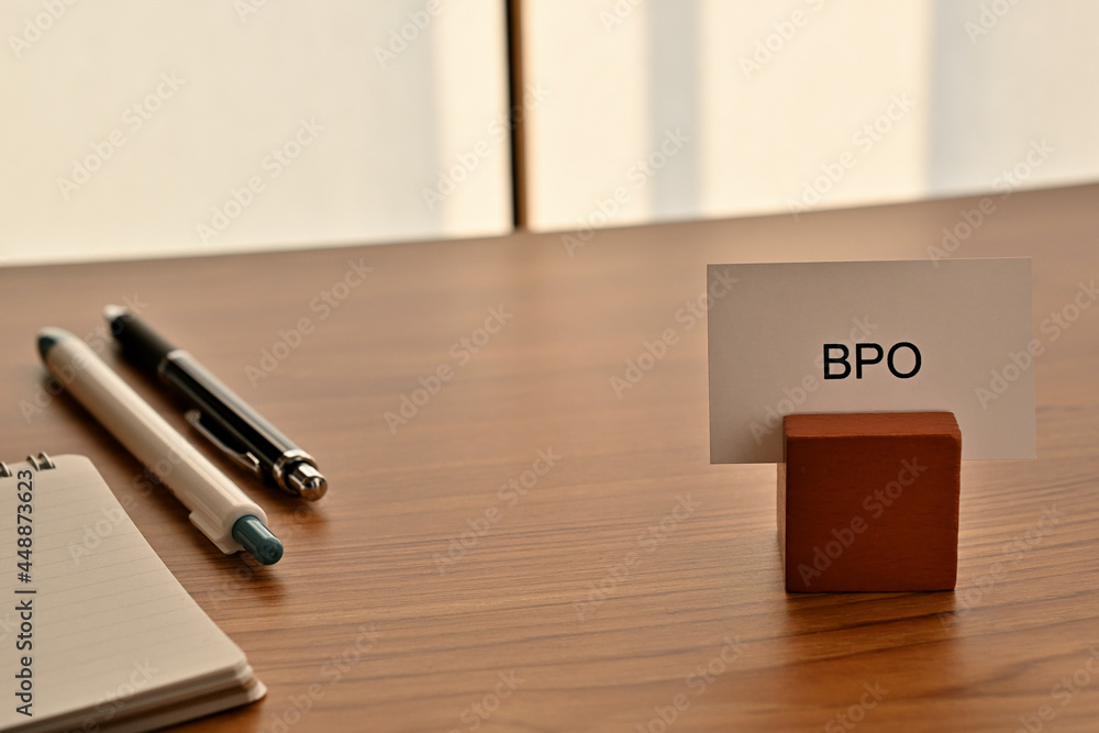 There is a card on paper stand with the word of BPO which is an ...