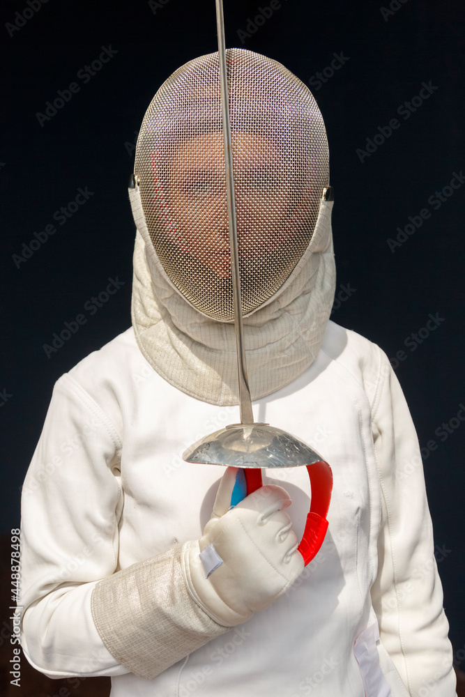 Female fencer touching helmet with foil Stock Photo | Adobe Stock
