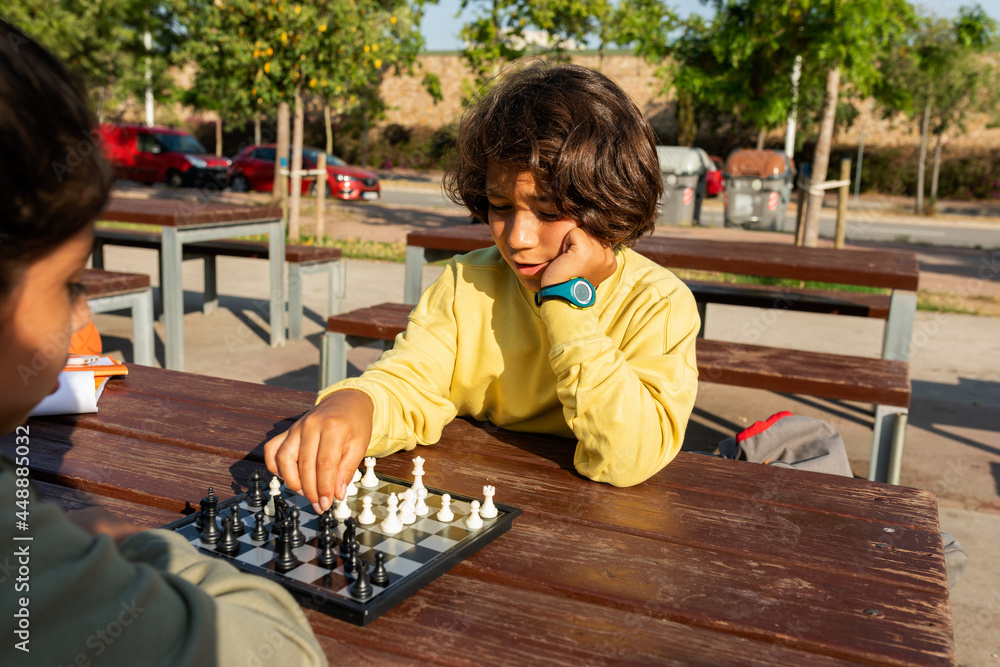 Kids playing chess outdoor Stock Photo | Adobe Stock