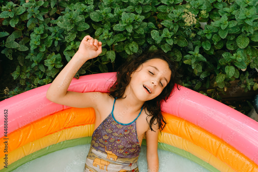 Little girl having fun inside inflatable swimming pool Stock Photo ...