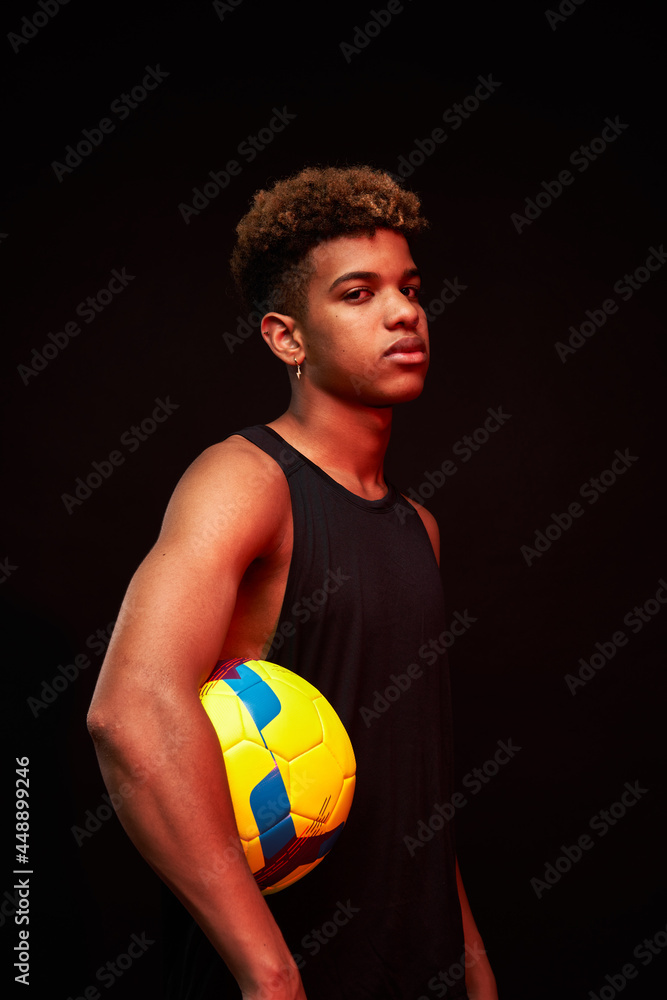 Black man with soccer ball in studio Stock Photo | Adobe Stock