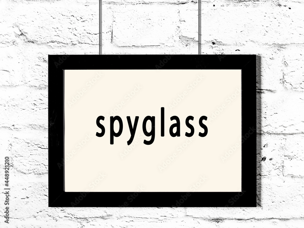 Black frame hanging on white brick wall with inscription spyglass Stock ...