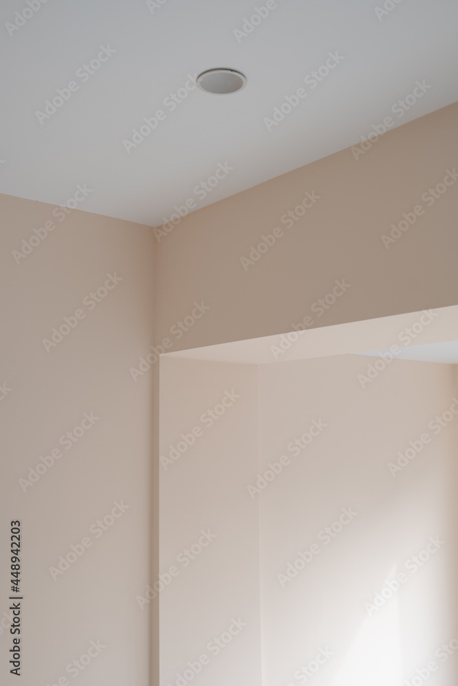 Vertical shot of the upper corner of pinky walls and a fan hole in the ...