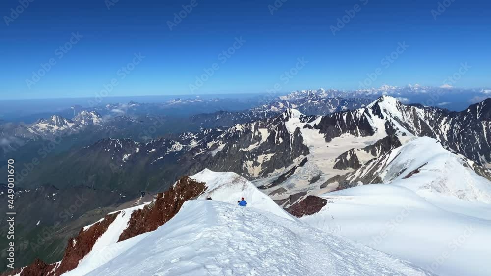 A climber descends from the top of Mount Kazbek. A majestic panorama of ...