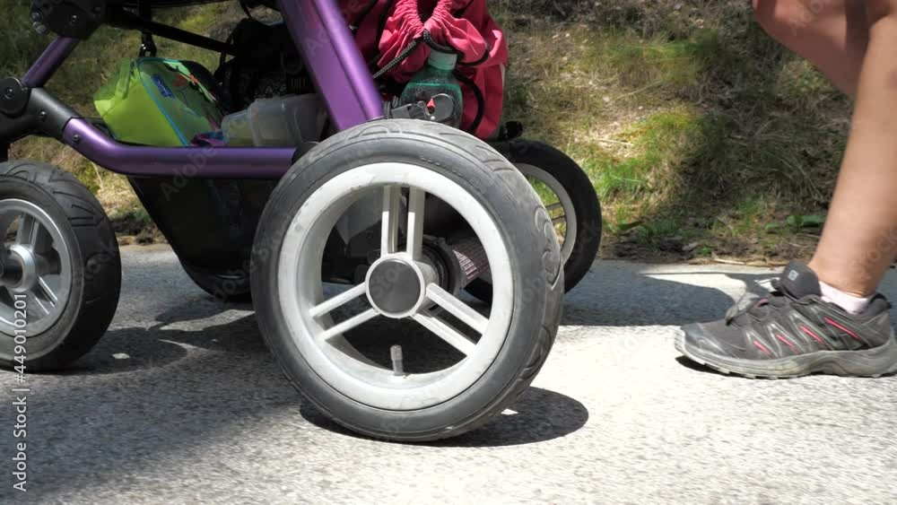 Video Stock Turning rear wheel of baby pram and mother feet while walk ...