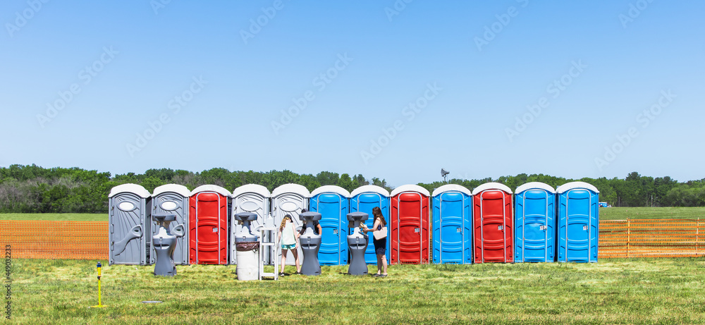 Row of colorful mobility lavatory and washbasin, hygiene facility for ...