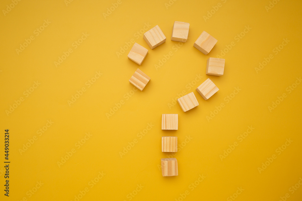 Question mark concept with arranging wooden blocks isolated yellow ...
