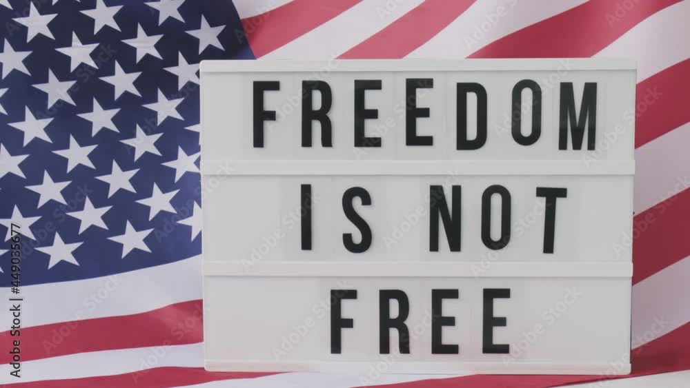 4k Waving American Flag Background. Lightbox with text FREEDOM IS NOT ...
