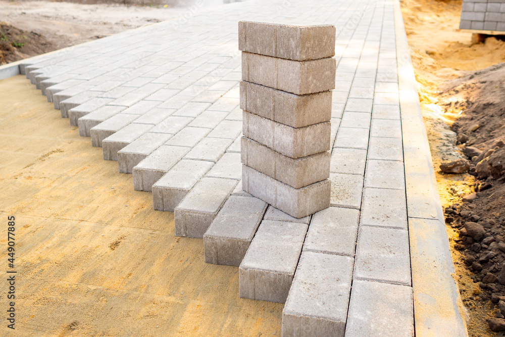 Top view of the edge of surface with laid gray paving slabs. Surface ...