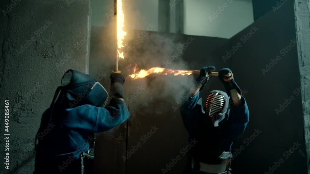 Japanese kendo fighters with burning swords competing in the fog in ...