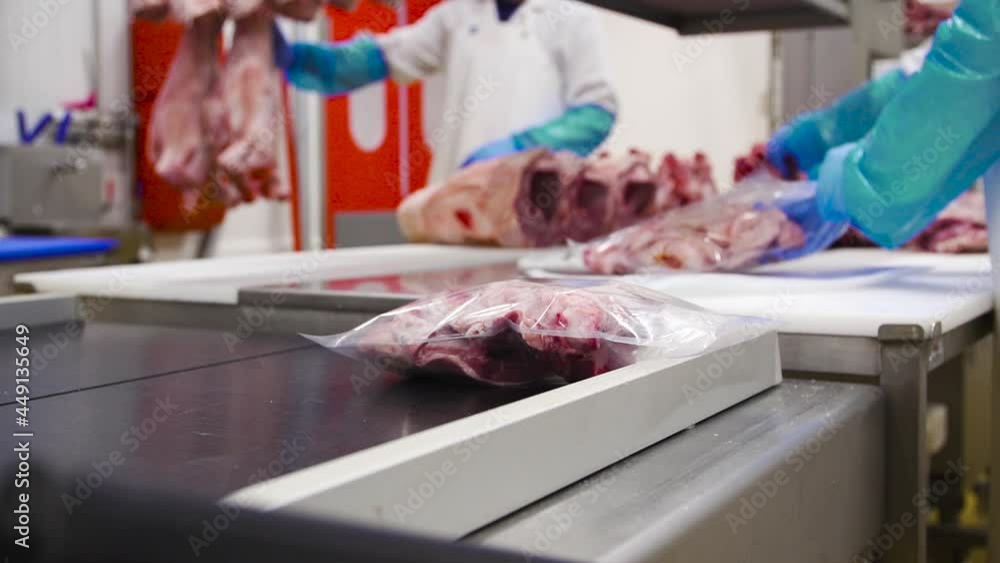 In a butcher's shop, the vacuum packaging of a package of suckling lamb ...