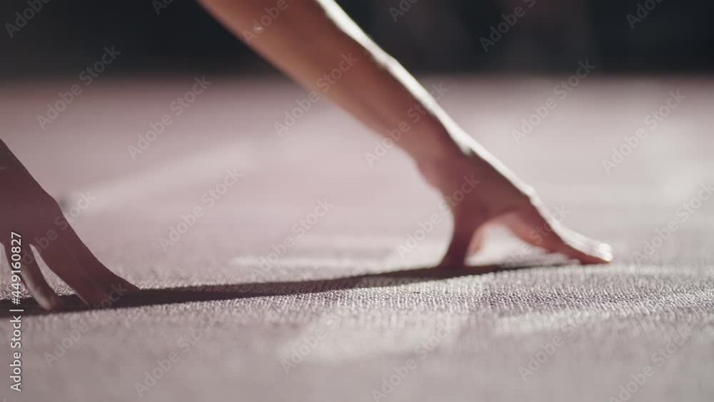 Woman hand on track as he crouches in starting position at the ...