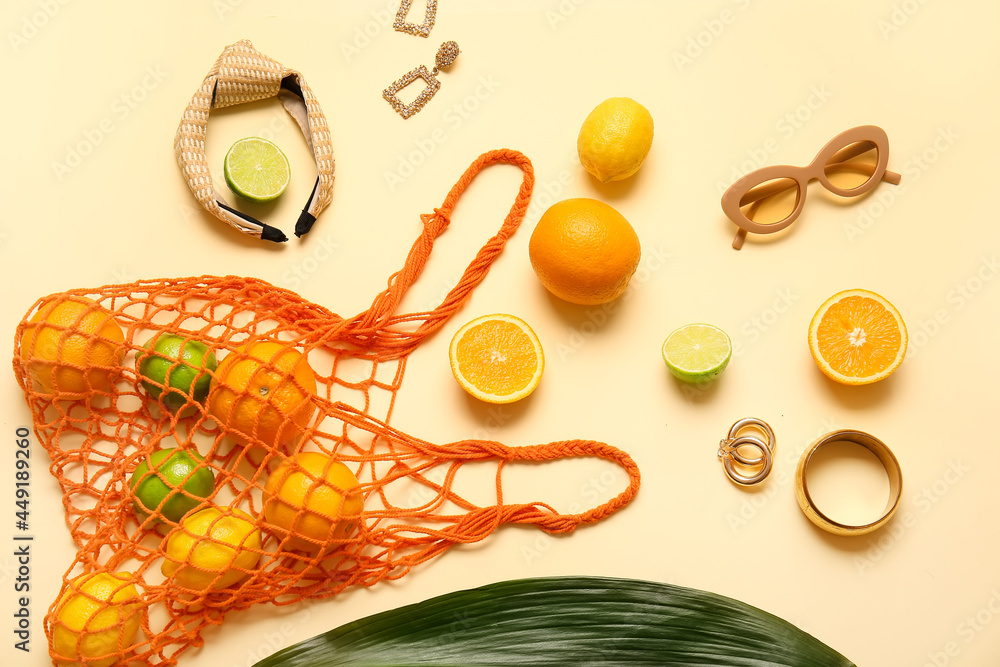 Composition with female accessories and citrus fruits on color ...