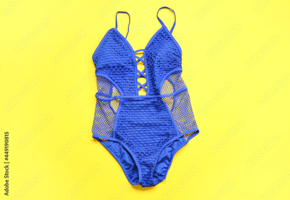 Stylish swimsuit on color background Stock Photo | Adobe Stock