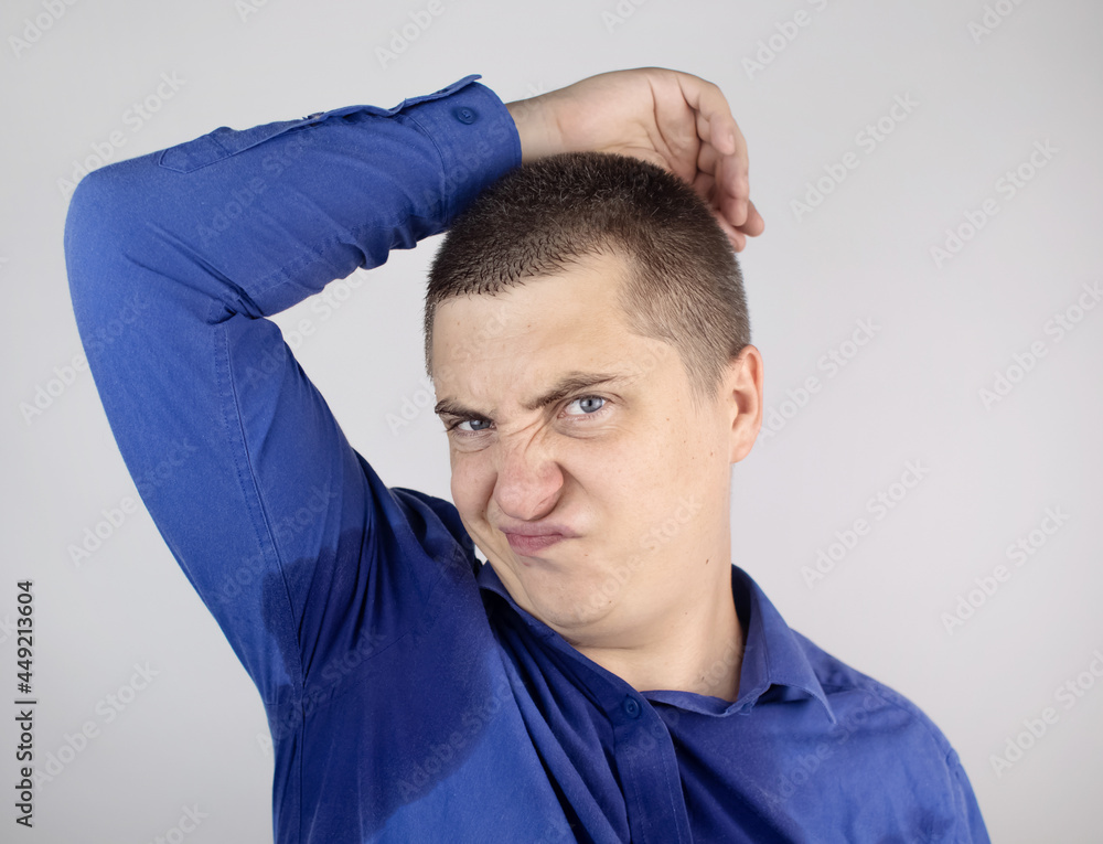 The man shows his sweaty armpits to the camera. Close-up of sweat drops ...