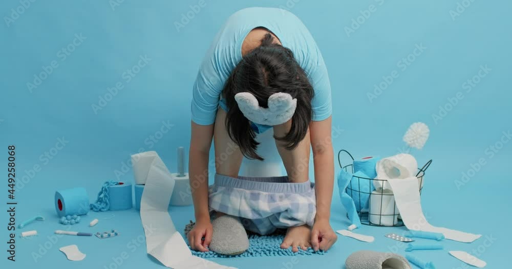 Sleepy brunette woman leans to feet poses on toilet bowl reveals ...