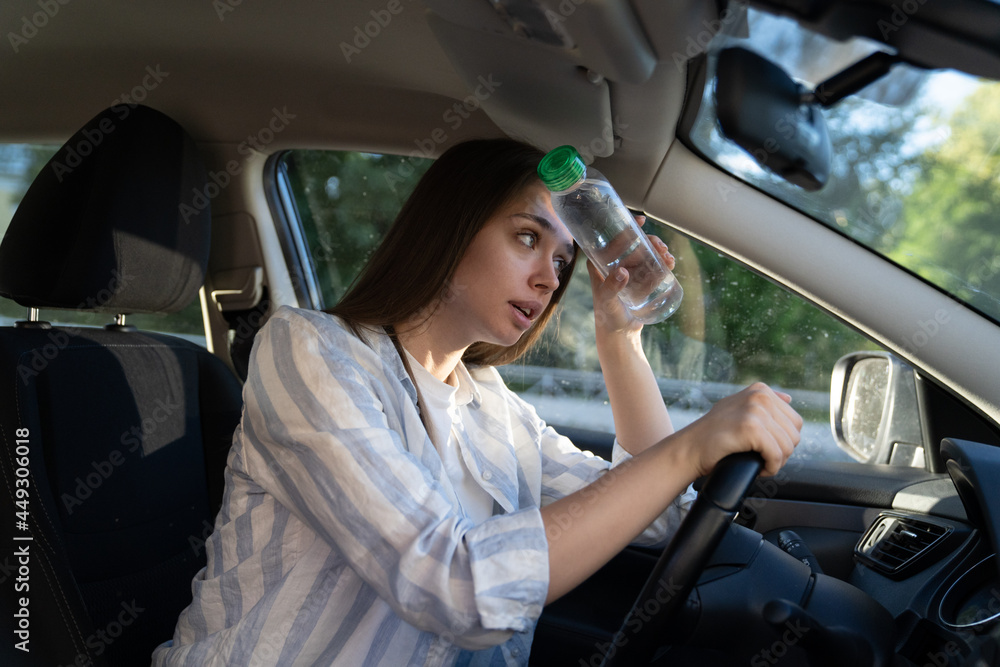 Exhausted woman driver feeling headache, sitting inside her car ...