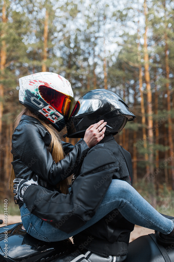 Motorcyclist in leather outfit sits with a girl on a motorcycle in ...
