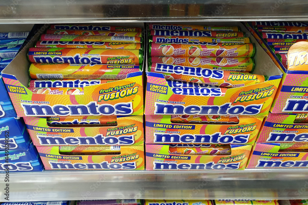 Various choices Mentos brand candy and gum display on the store shelf ...