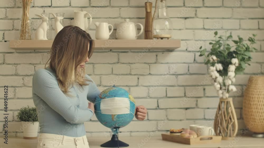 Girl put on mask on globe. Covid worldwide pandemic quarantine. Planet ...