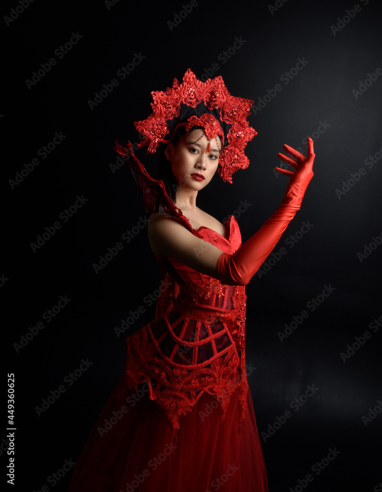 Full length portrait of beautiful young asian woman wearing red corset ...