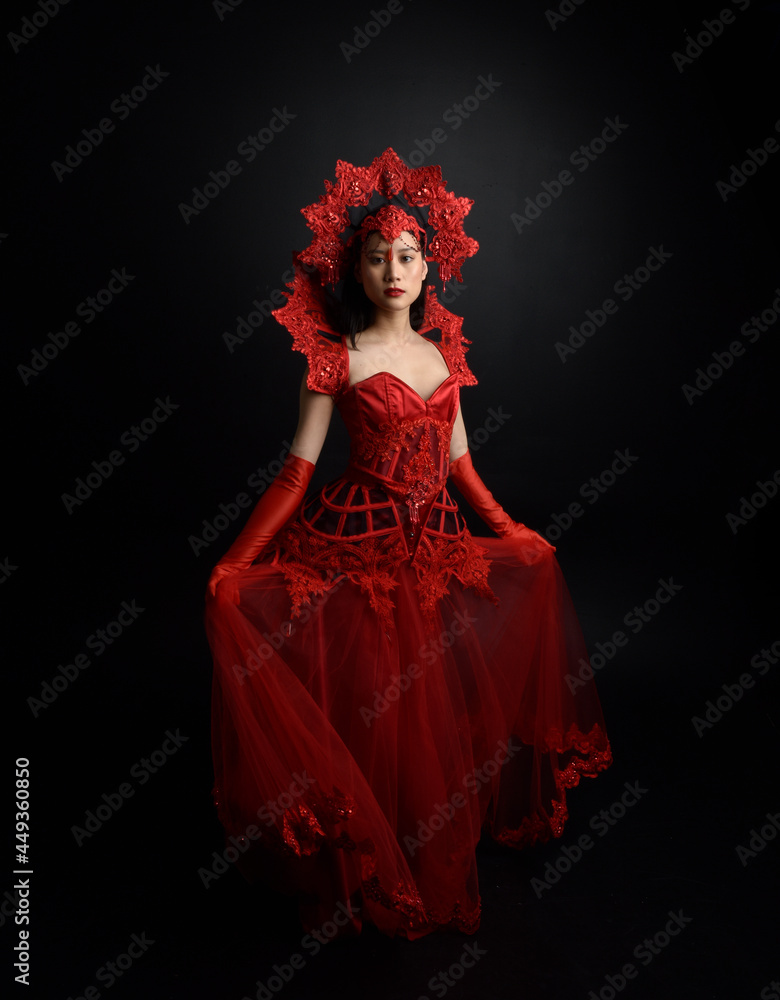Full length portrait of beautiful young asian woman wearing red corset ...